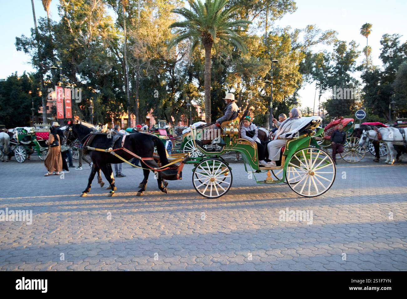 people on a horse and carriage ride in arset el bilk jemaa el fna ...