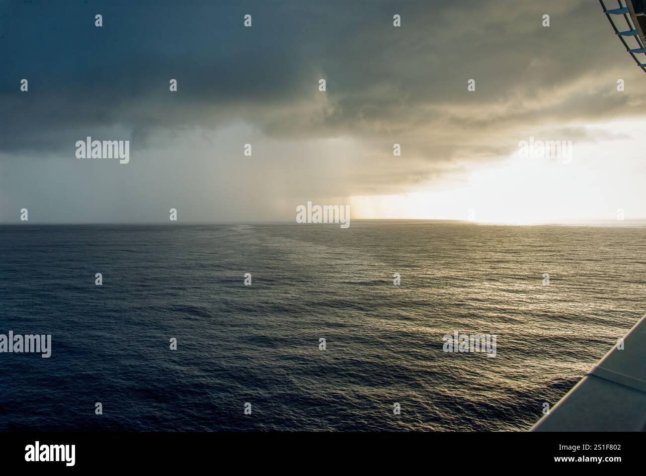 A dramatic interplay of light and shadow over the open sea as storm ...