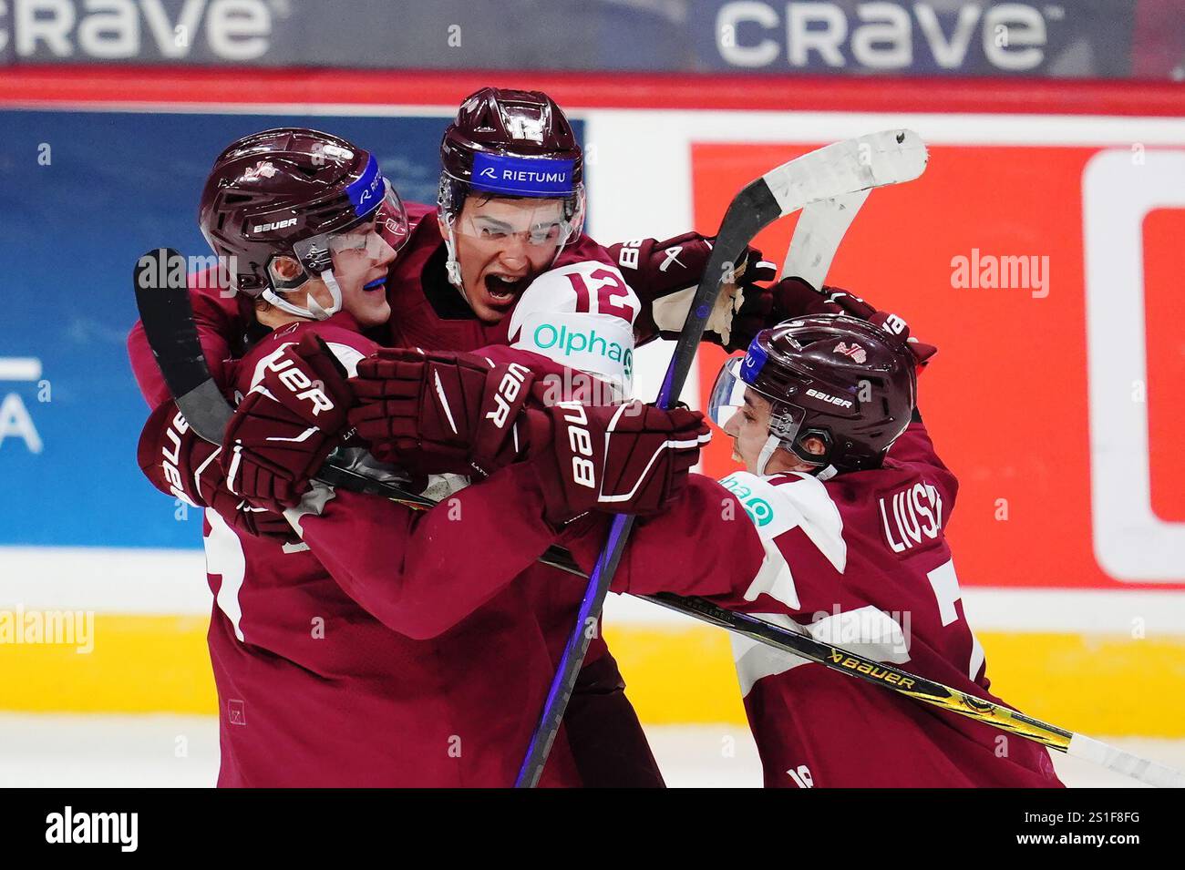 Ottawa, Canada. 27th Dec, 2024. Latvia's Eriks Mateiko (left ...