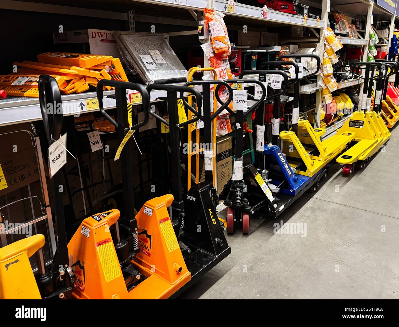 A selection of industrial pallet trucks in various colors and sizes in ...