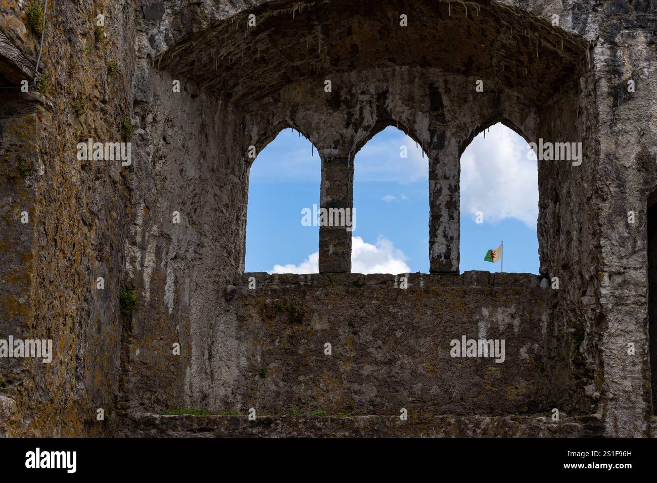 Pembroke Wales - August 3 2024; Three vaulted window opening to blue sky in alcove inside ...