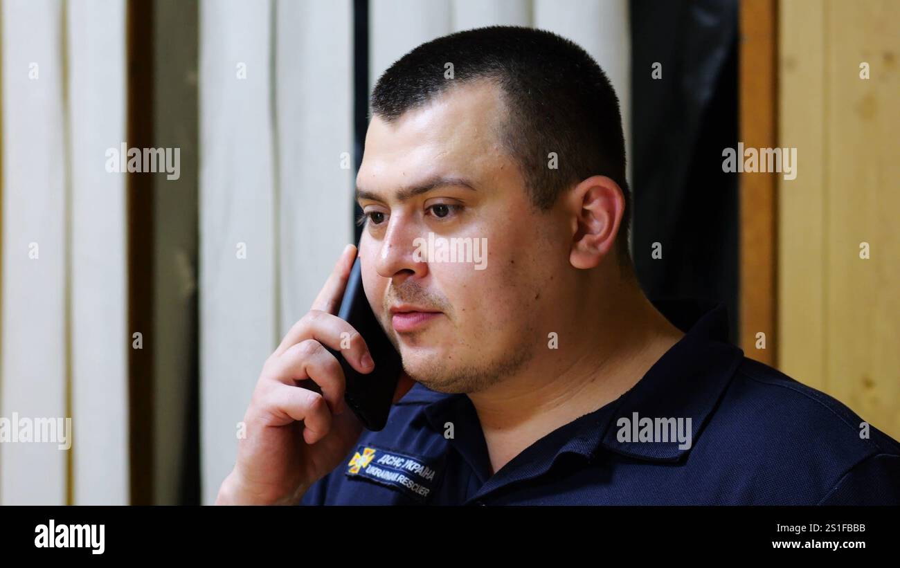 Male firefighter chief have serious telephone conversation with his ...