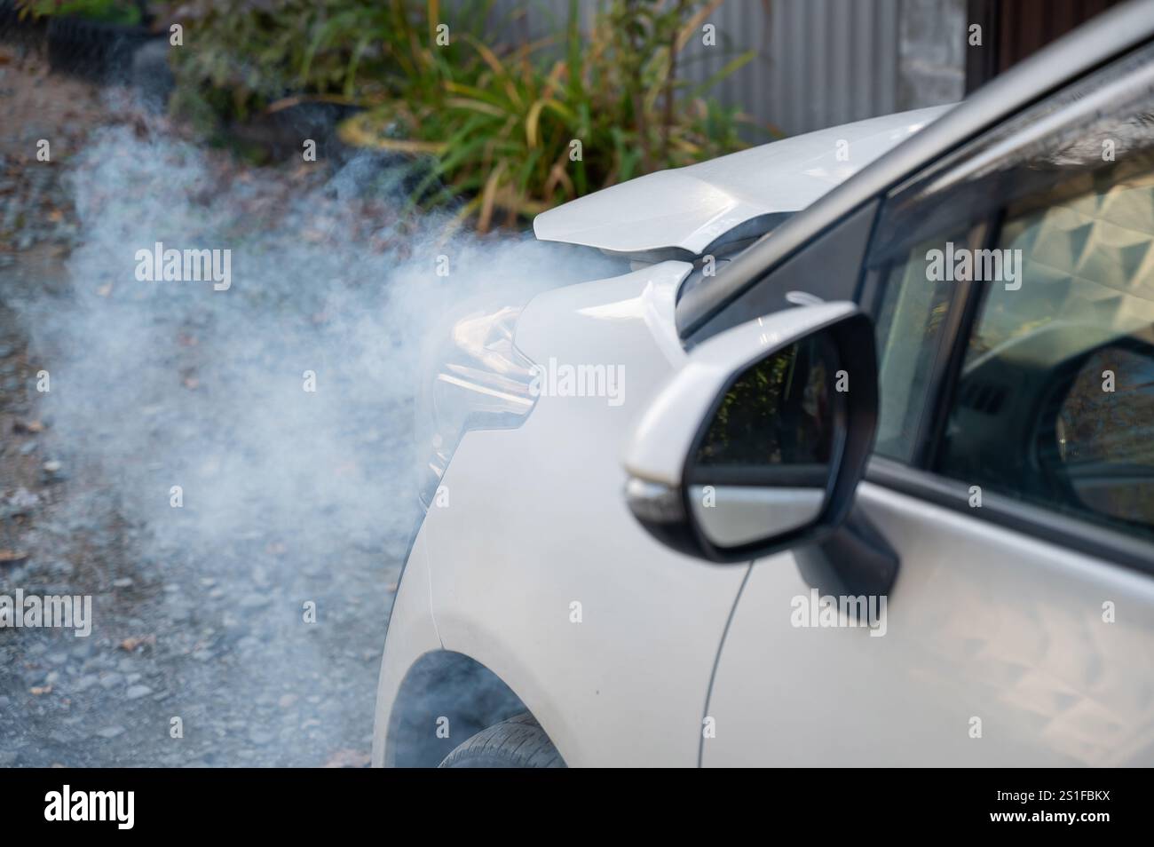 Smoke is coming from under the hood of the car Stock Photo - Alamy
