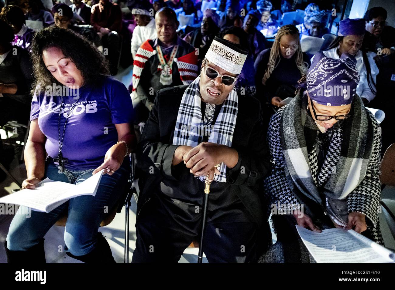 AMSTERDAM - Attendees sing during a Singi Neti for Desi Bouterse. The ...