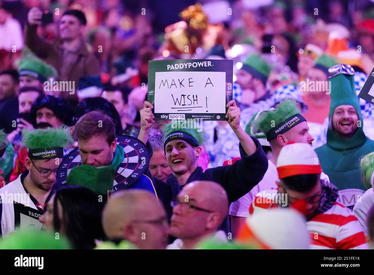 A darts fan holds up a sign ahead of the Paddy Power World Darts ...