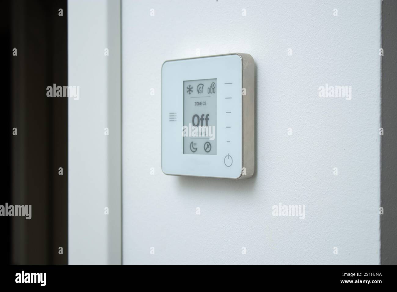A modern electric thermostat control system on white wall Stock Photo ...