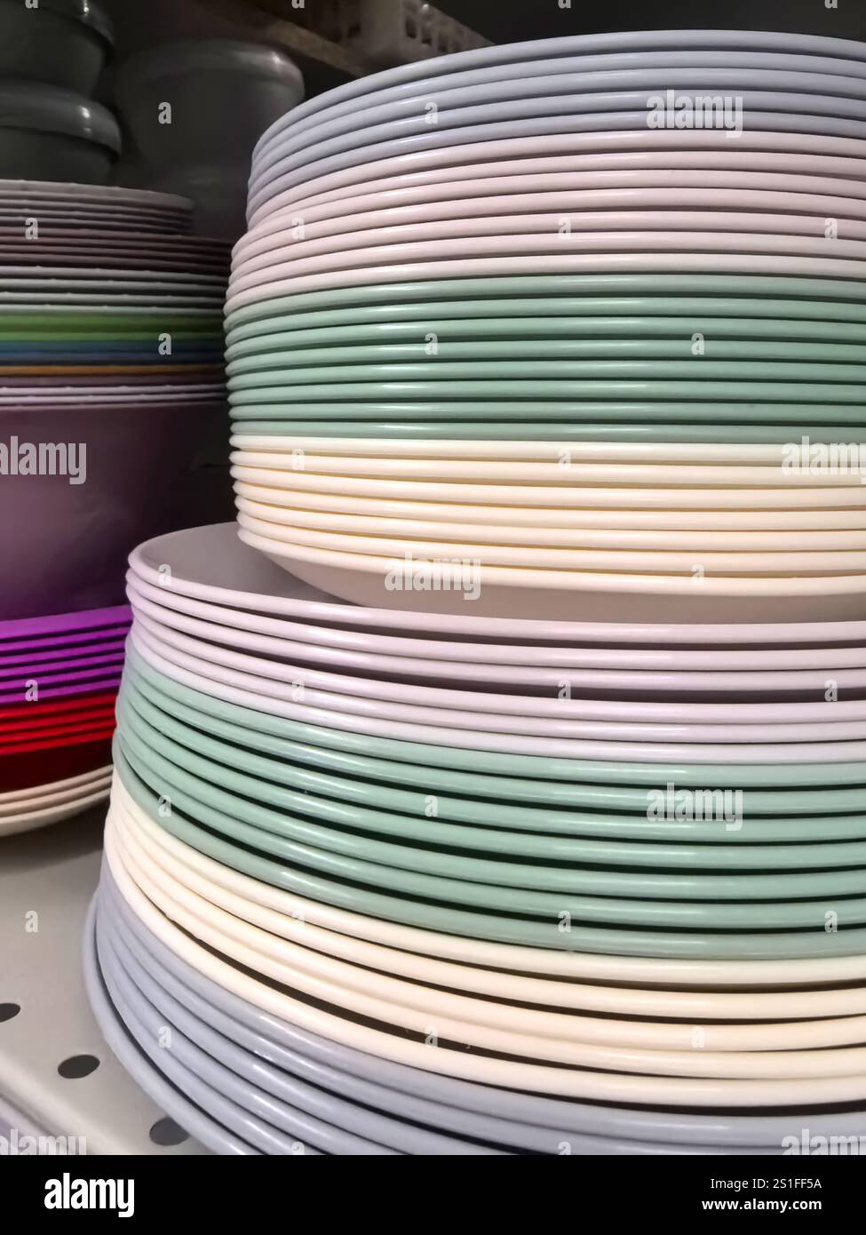 A collection of elegantly stacked ceramic plates showcases a variety of ...