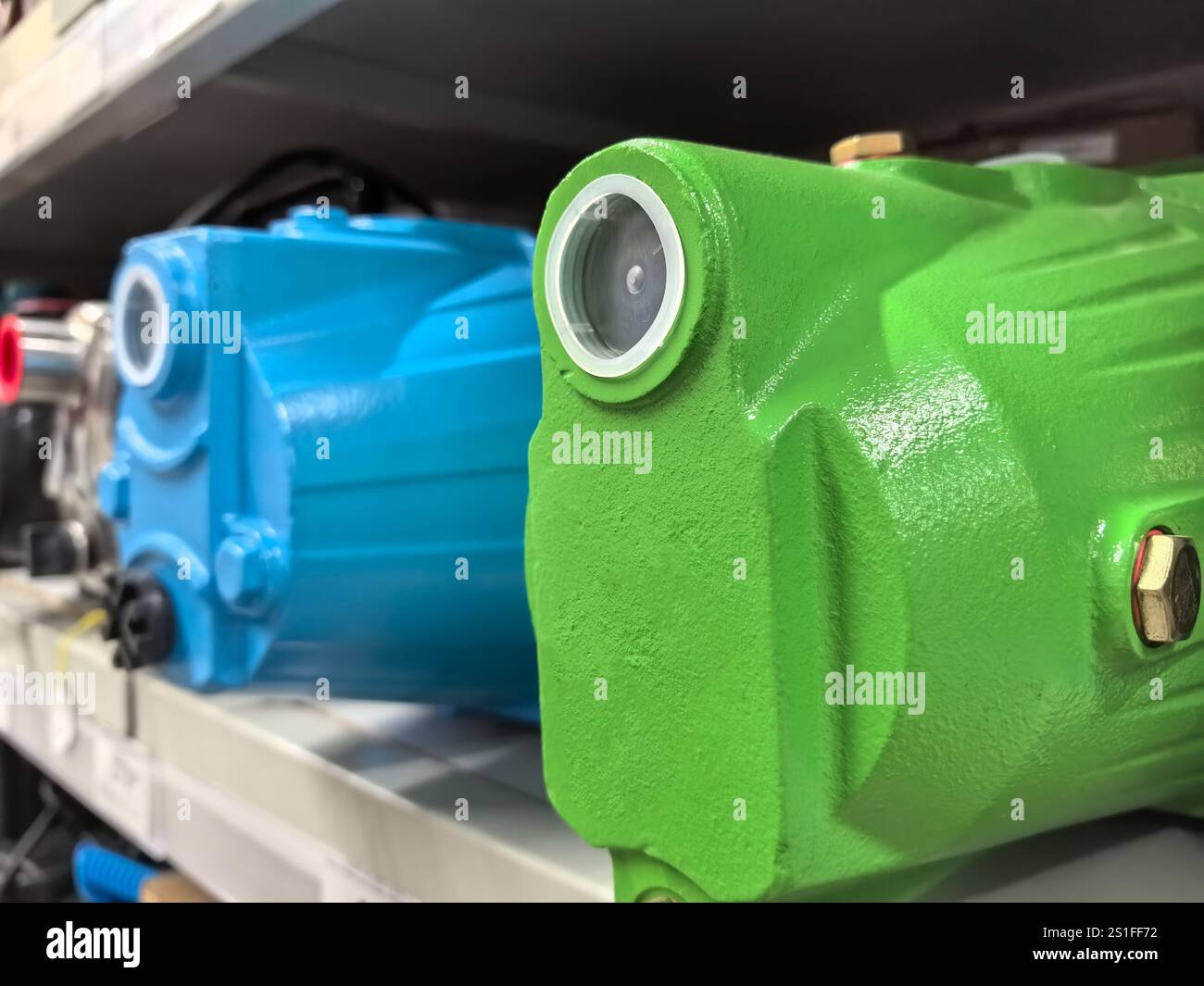 Brightly colored pumps in blue and green sit neatly on a shelf ...