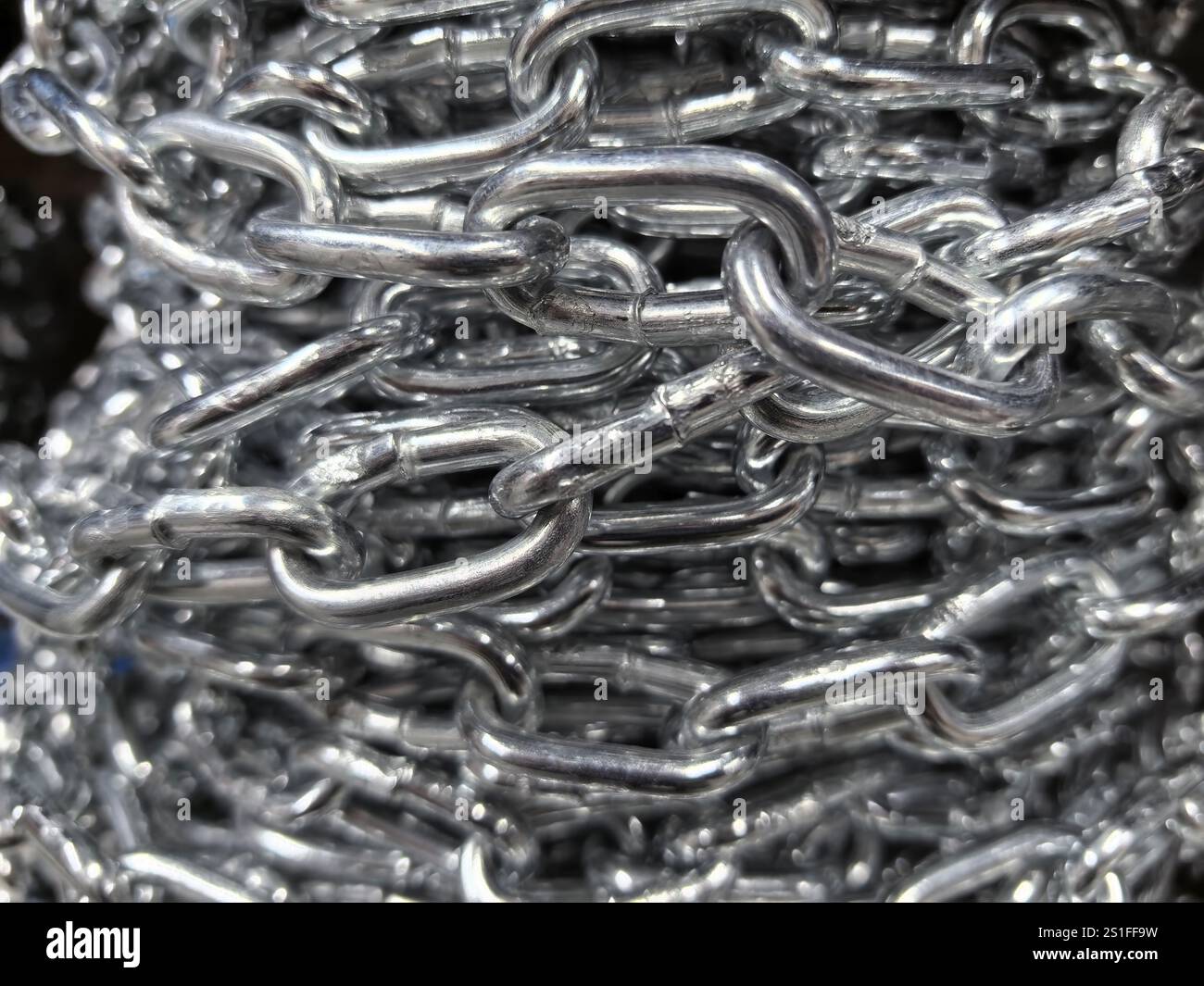 A close-up view reveals an intricate assortment of silver metal links ...