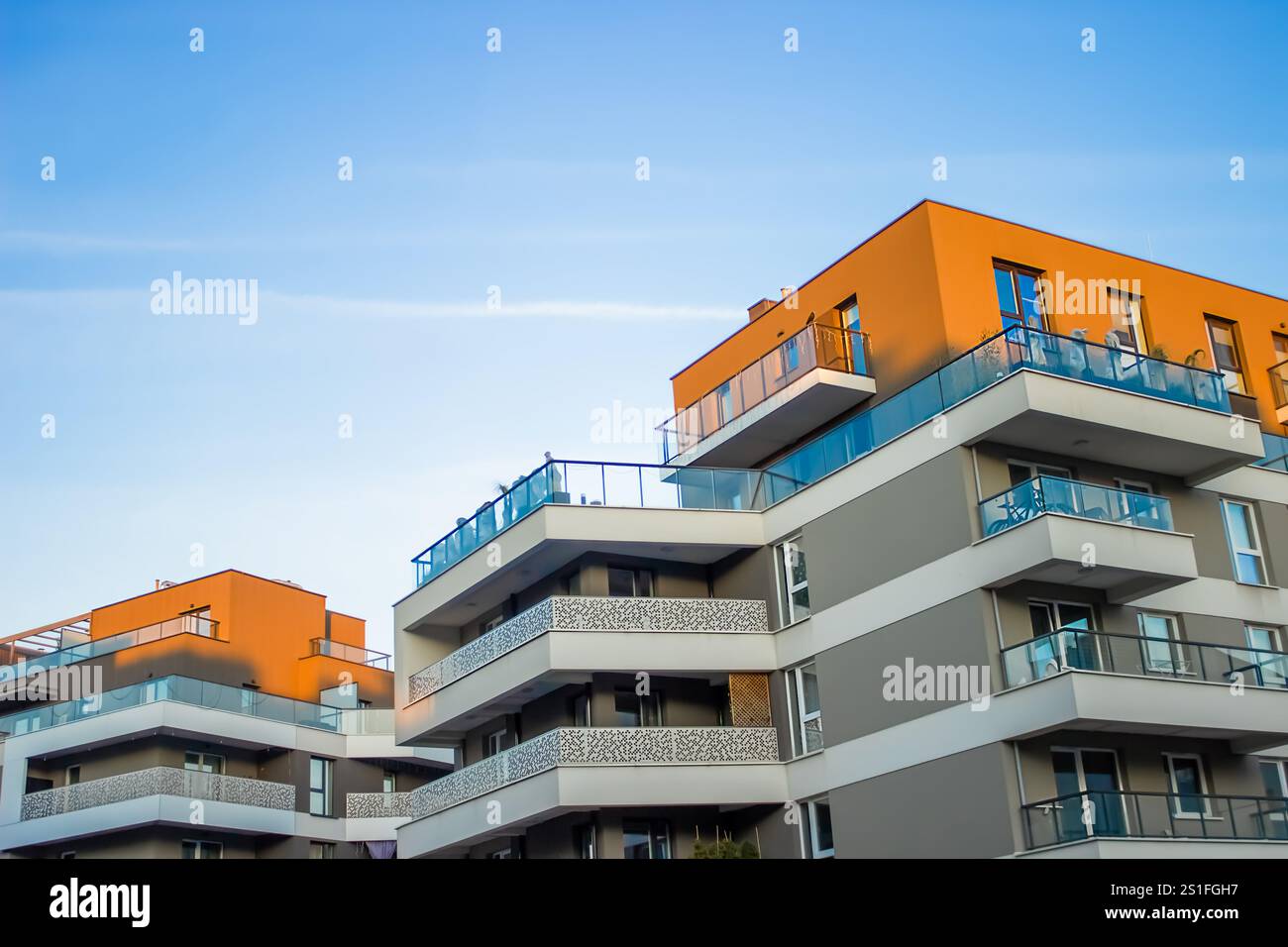 Multi-story gray buildings with wide continuous balconies and orange ...