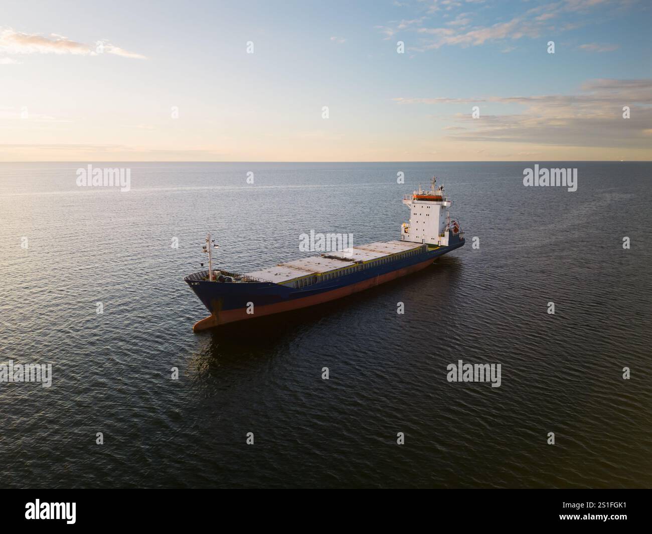 Cargo ship sailing sunset hi-res stock photography and images - Alamy