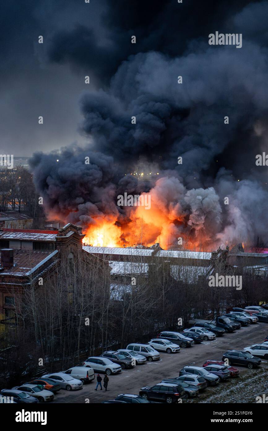 Heavy fire with acrid smoke in warehouse with toxic paint materials ...