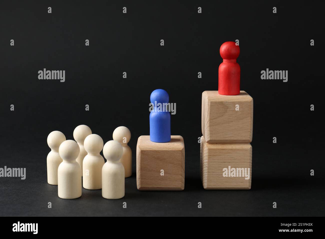 Competition concept. Human figures on wooden cubes and other ones ...