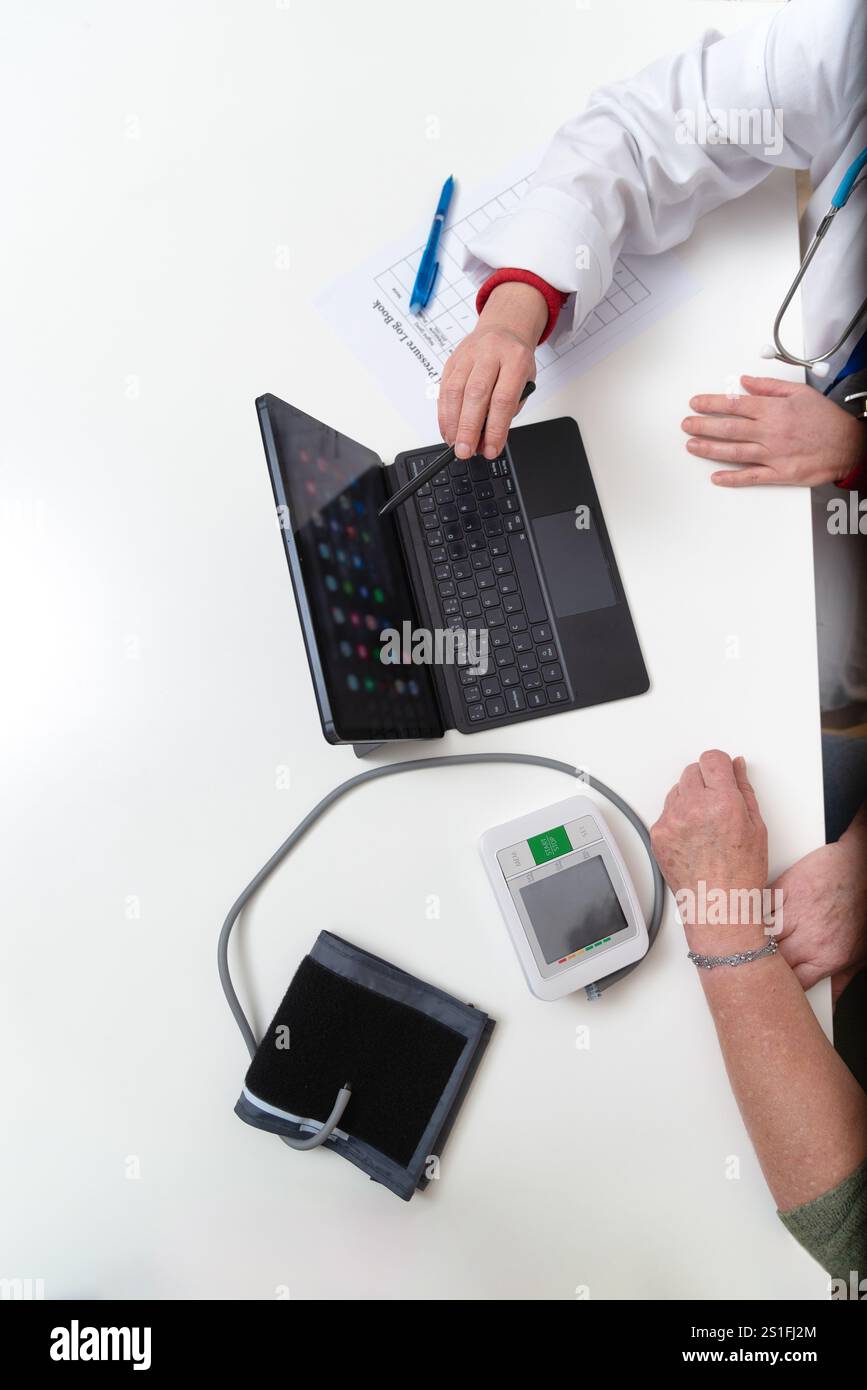 Doctor explaining medical app to patient using tablet and blood ...