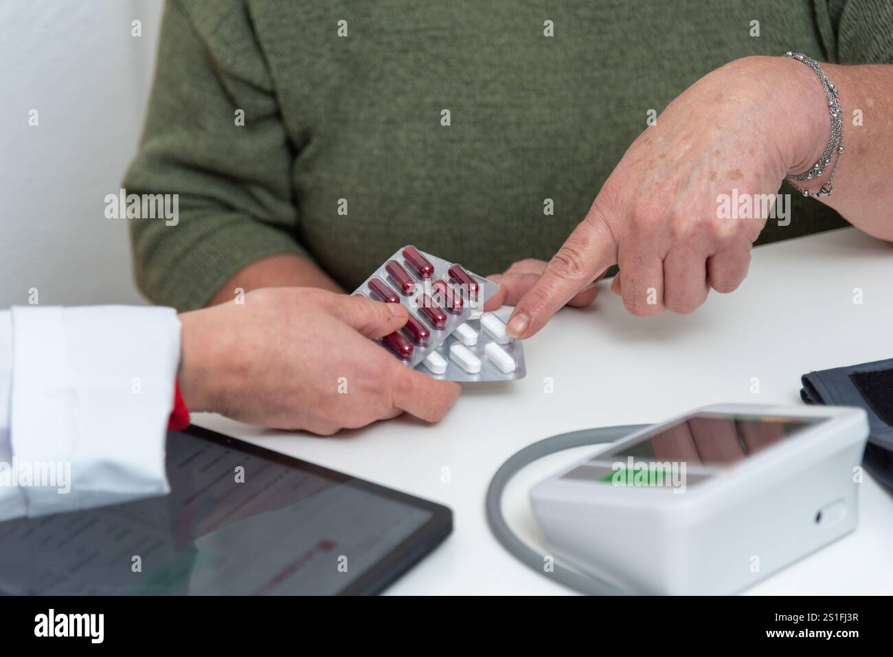 Doctor giving medical prescription to senior patient choosing medicine ...