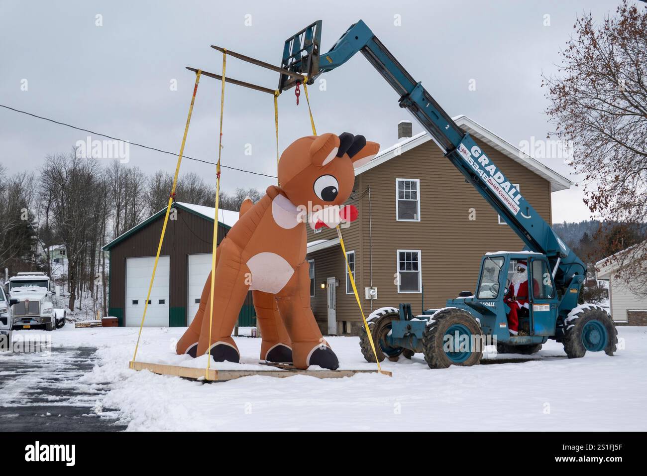 A giant inflatable Rudolph the Red-Nosed Reindeer decoration is posed ...