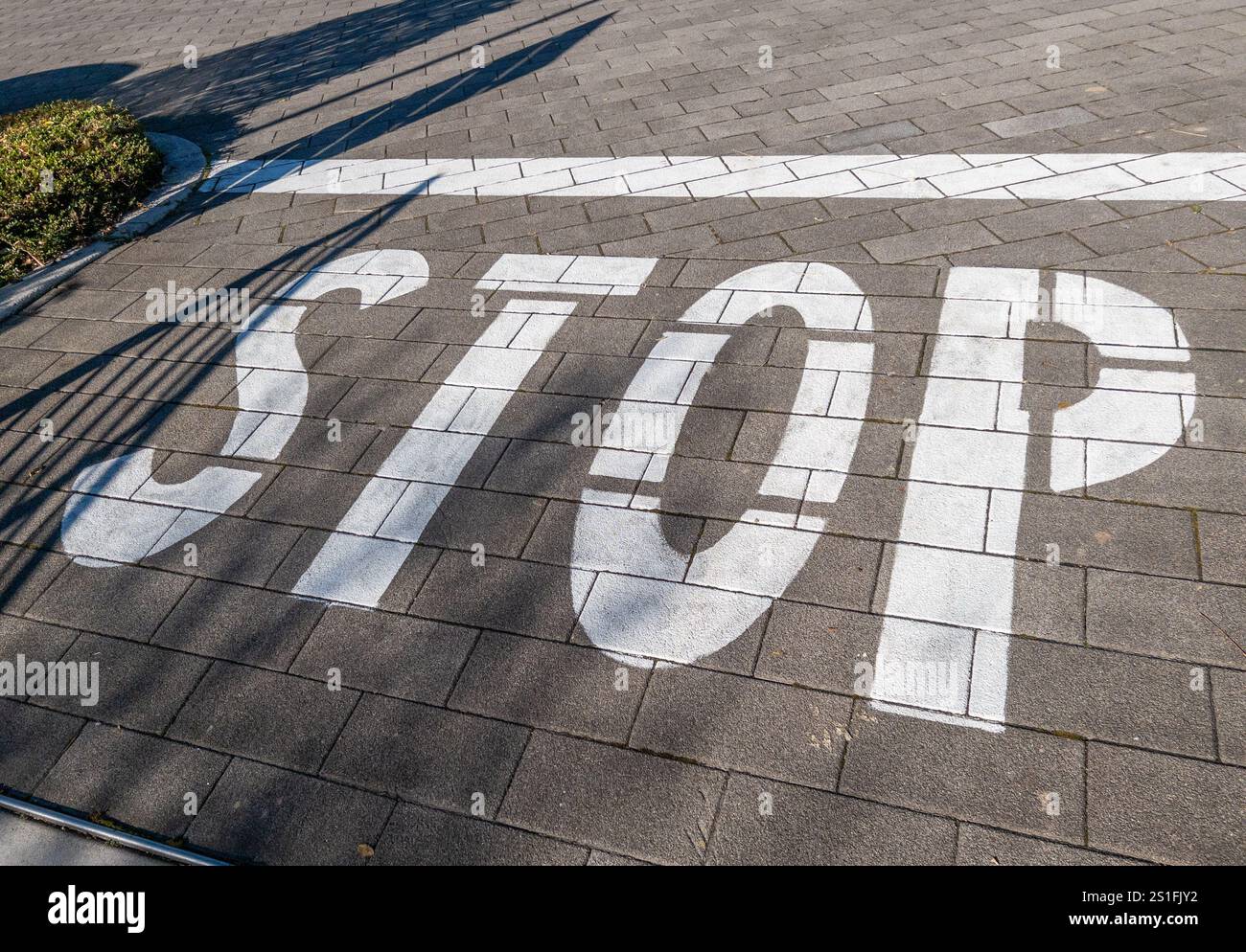 Stop sign white painted on the paved road Stock Photo - Alamy