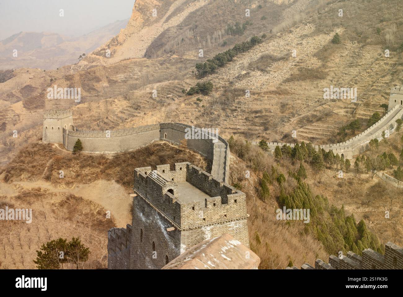 Ancient fortification winds across rugged terrain, showcasing the ...