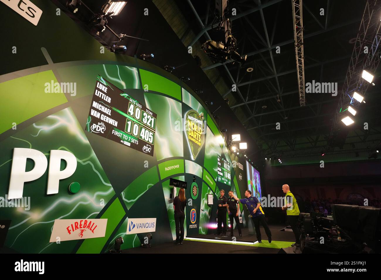 Luke Littler of England, second from right, throws his dart during the ...