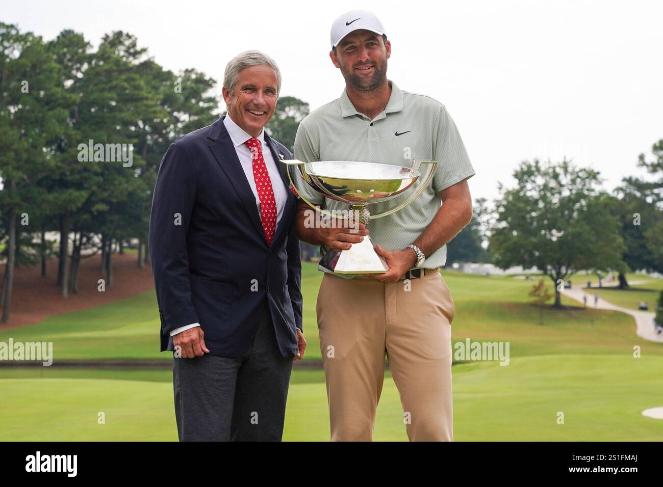 FILE - PGA Tour Commissioner Jay Monahan, left, poses with Scottie ...