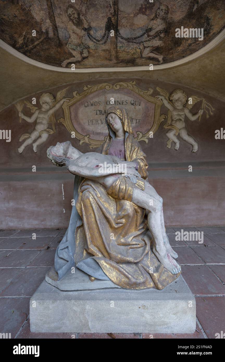 Sculpture of the Pieta, Mary holding Jesus in her arms in an outside ...