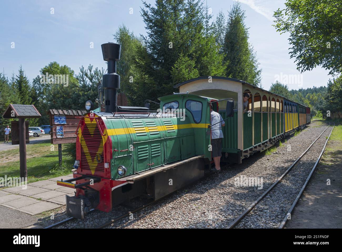 A train stands at a railway keeper's house in the forest, surrounded by ...
