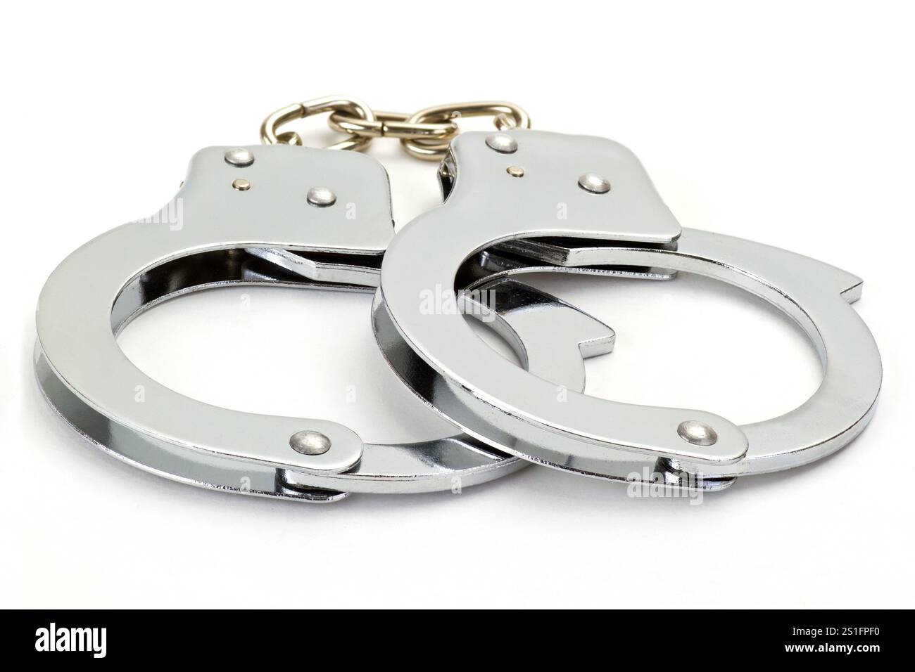 Handcuffs on a light background Stock Photo - Alamy