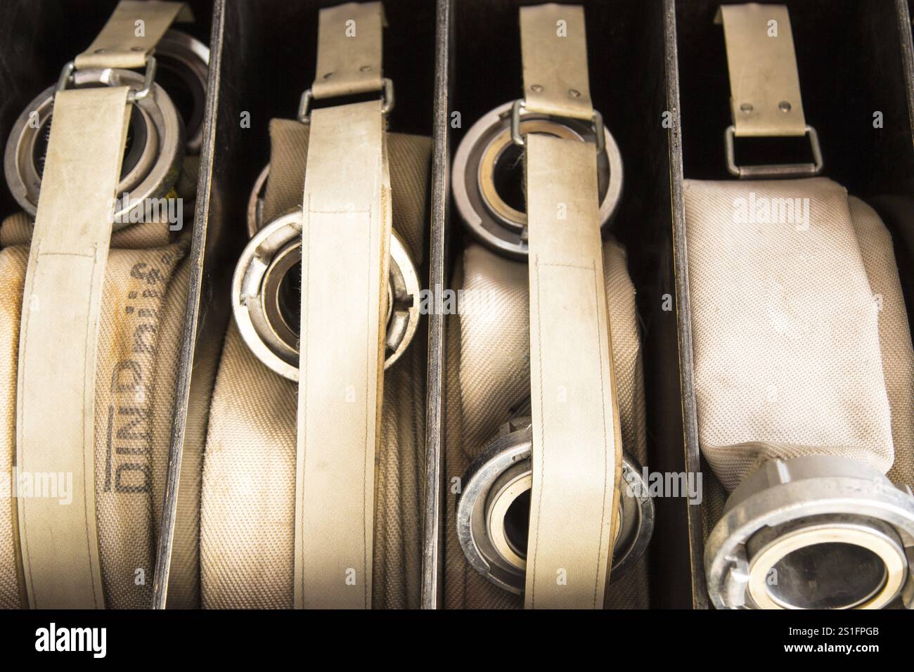 Rolled fire hoses on fire engine Stock Photo - Alamy