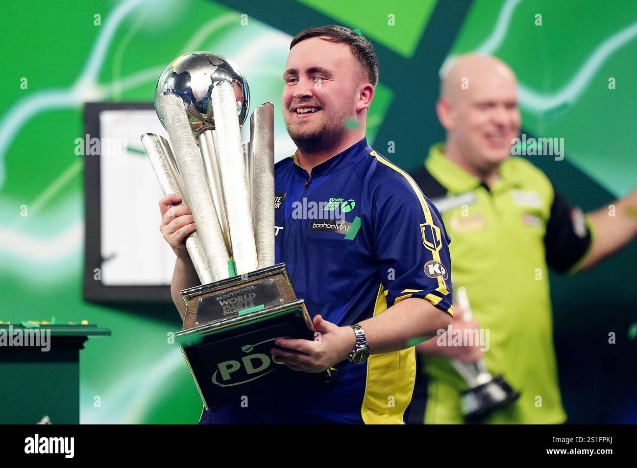 Luke Littler lifts The Sid Waddell Trophy after winning the Paddy Power ...