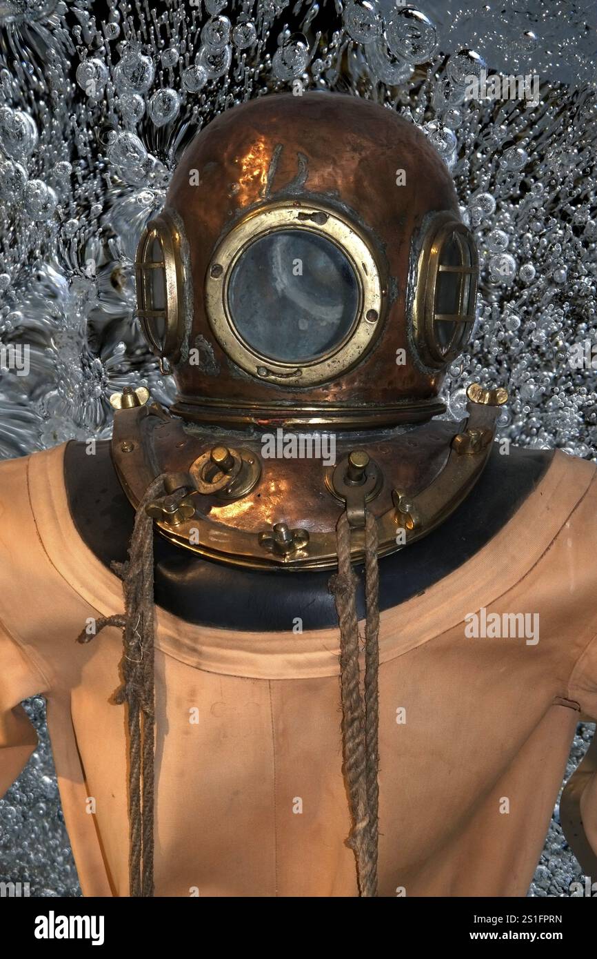 Diving suit with metal diving helmet with round viewing windows in ...