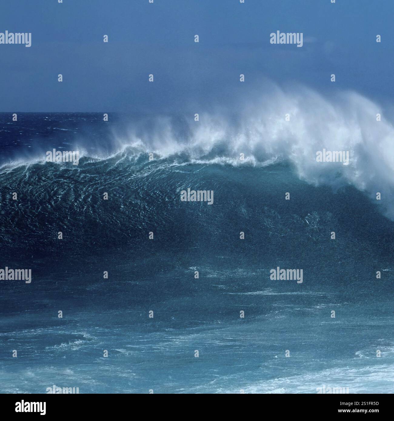 Wave piles up metres high in front of rolling over. Square. Wave towers ...