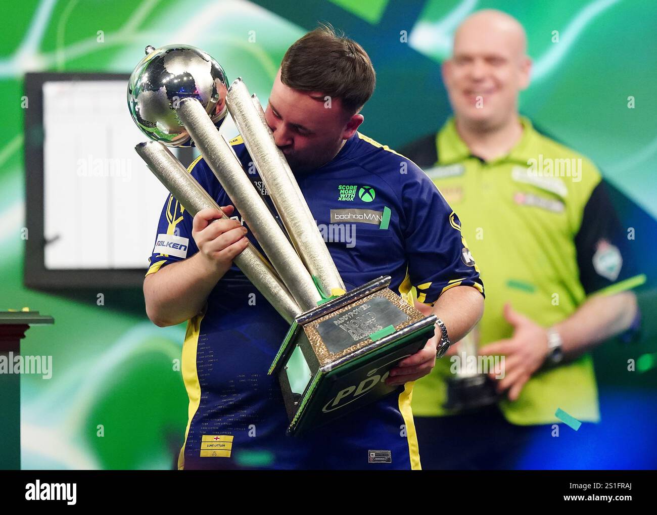 Luke Littler kisses The Sid Waddell Trophy after winning the Paddy ...
