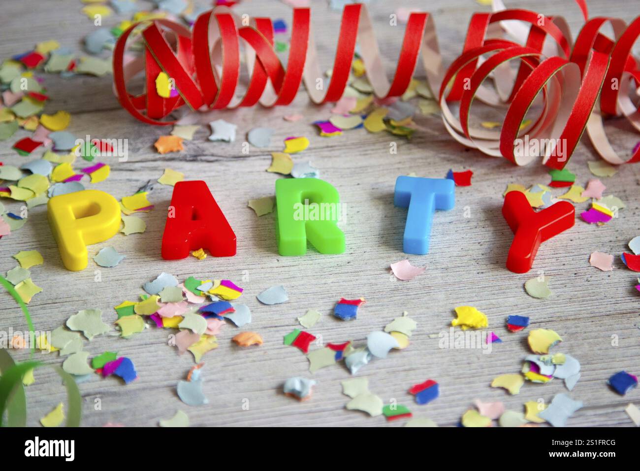 Party lettering with colourful letters and confetti Stock Photo - Alamy