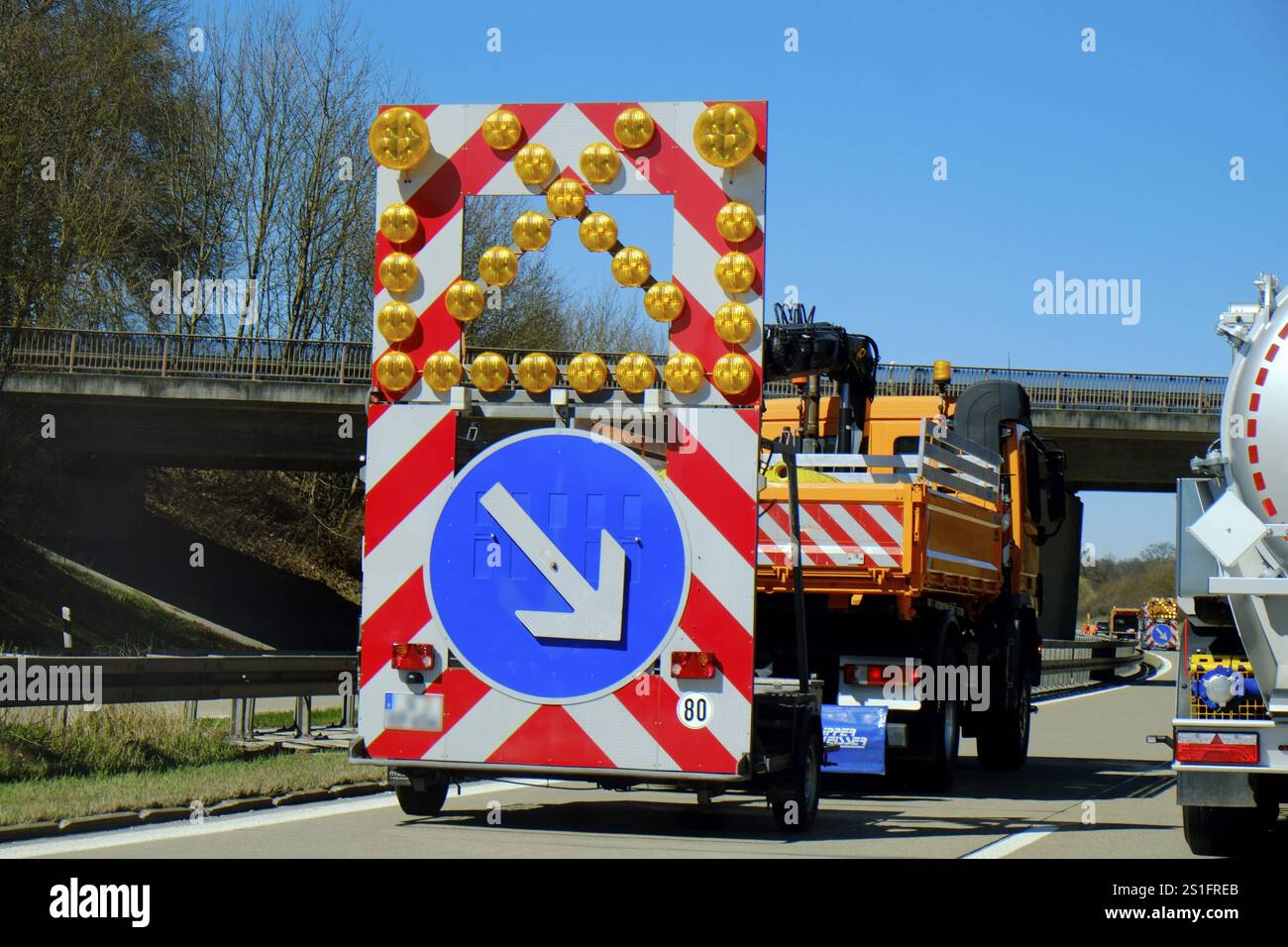 Safety vehicle with barrier board on the left lane of a motorway ...