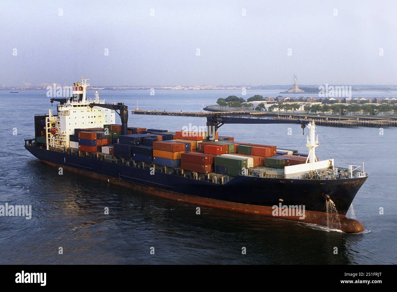 Container ship approaches its berth off Brooklyn at a slow speed on the ...