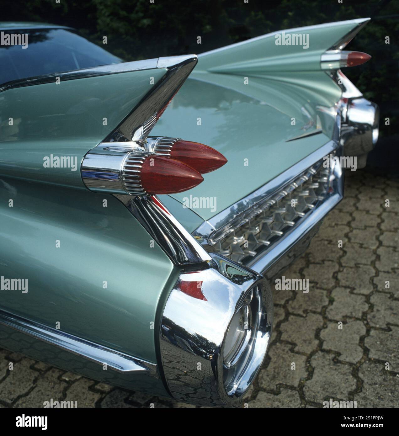 Tail fins, tail lights and bumper of a turquoise American road cruiser ...