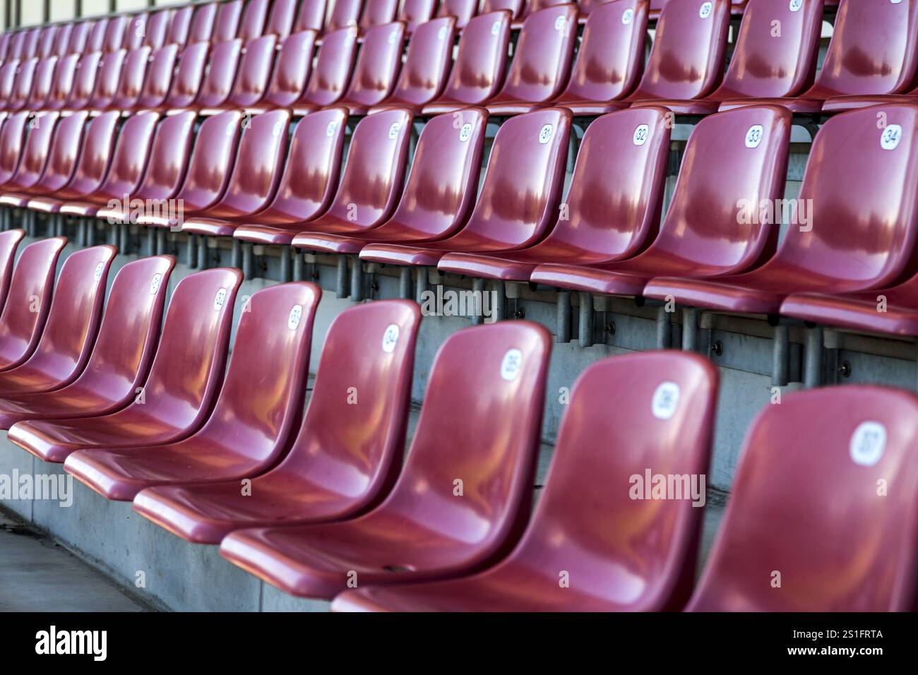 Empty red seating in a stadium Stock Photo - Alamy