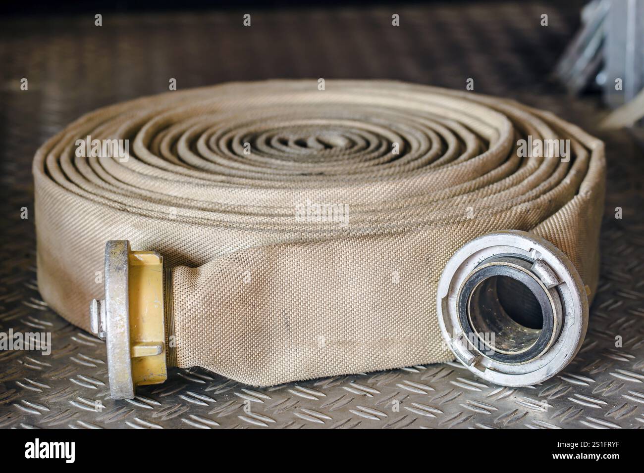 Coiled fire hose in detail Stock Photo - Alamy