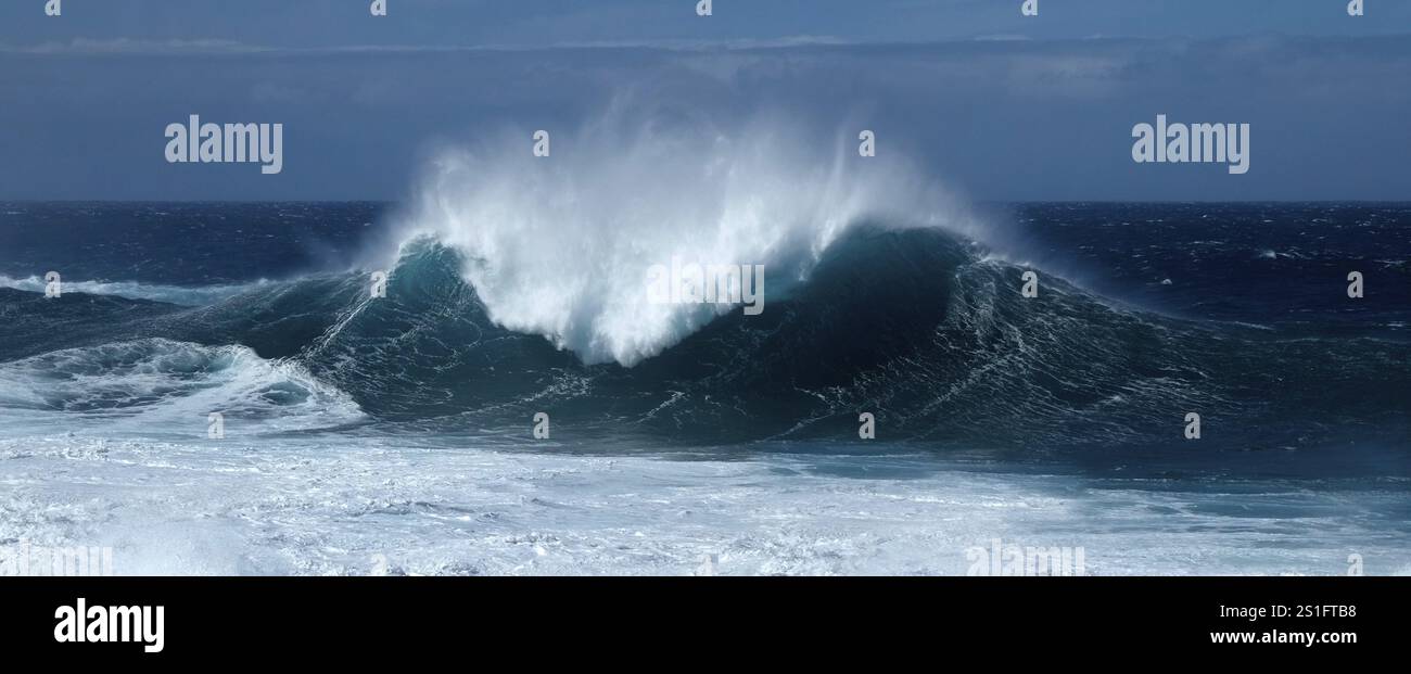 Single towering wave overturns. Panorama format. A single high towering ...