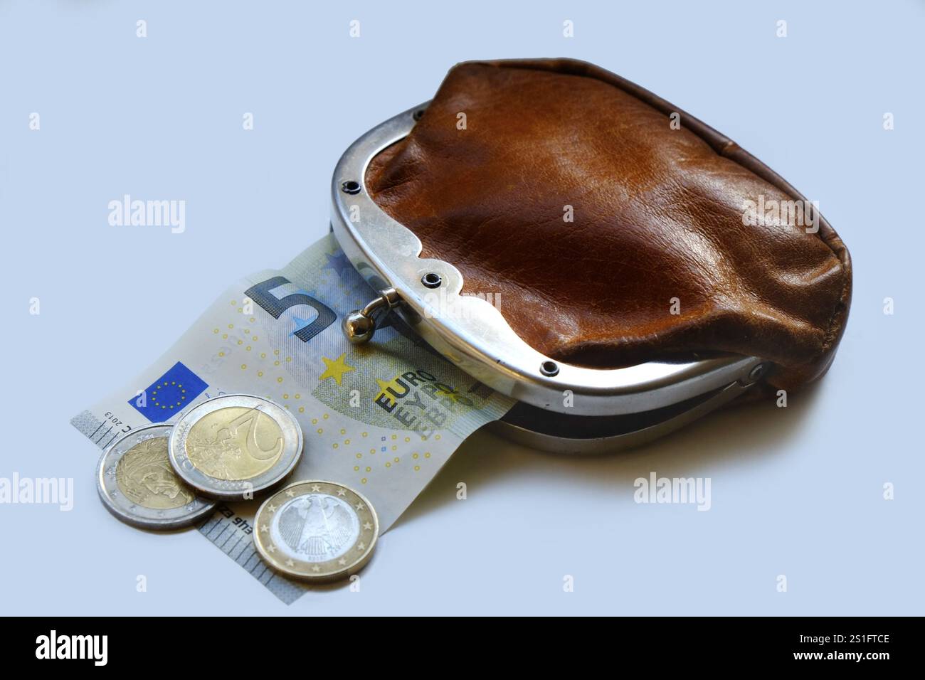 Slightly opened old-fashioned purse made of brown leather with a ...