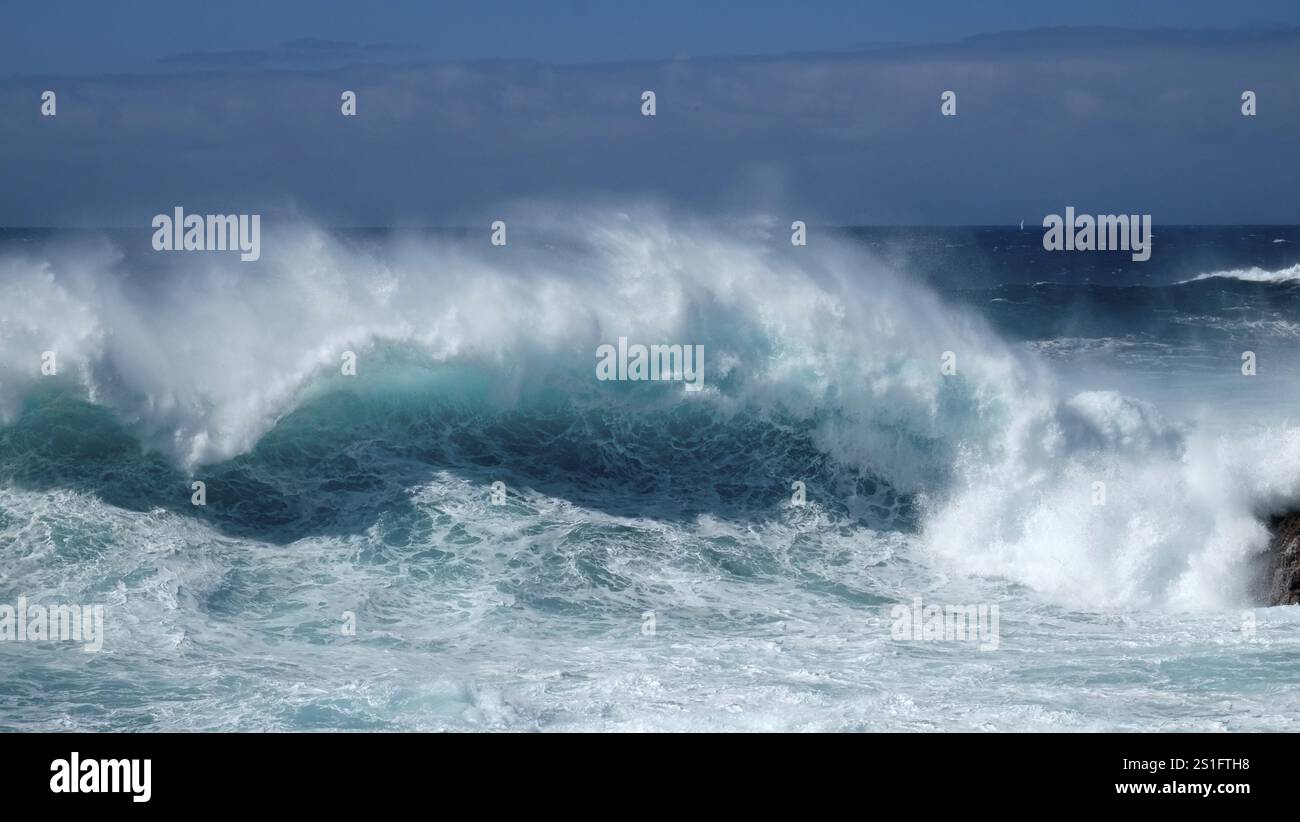 Turquoise-coloured wave crashes thunderously in the surf zone ...