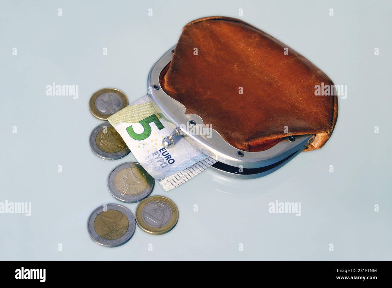 Slightly opened old-fashioned purse made of brown leather, with a five ...
