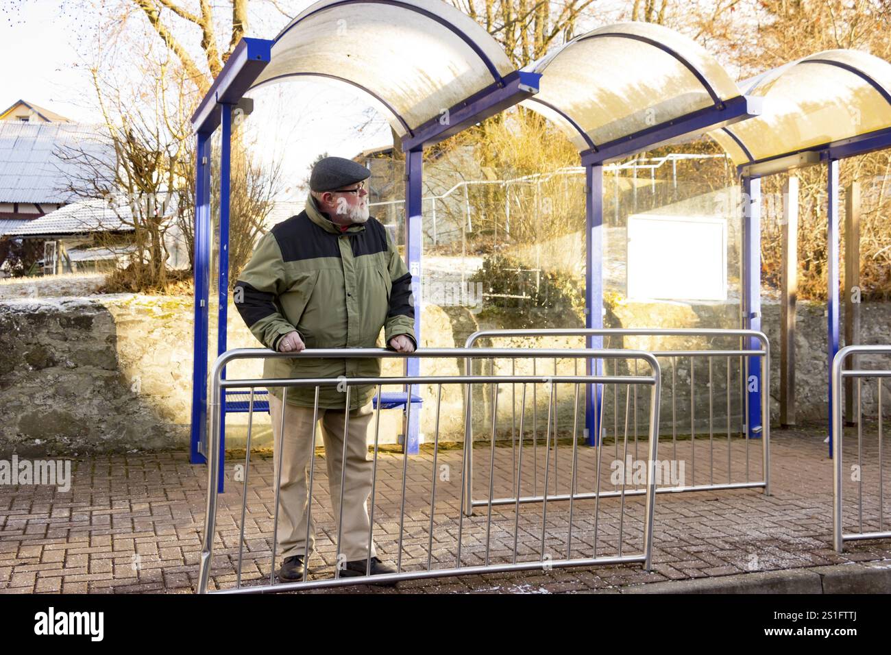 Senior citizen waiting at bus stop Stock Photo - Alamy