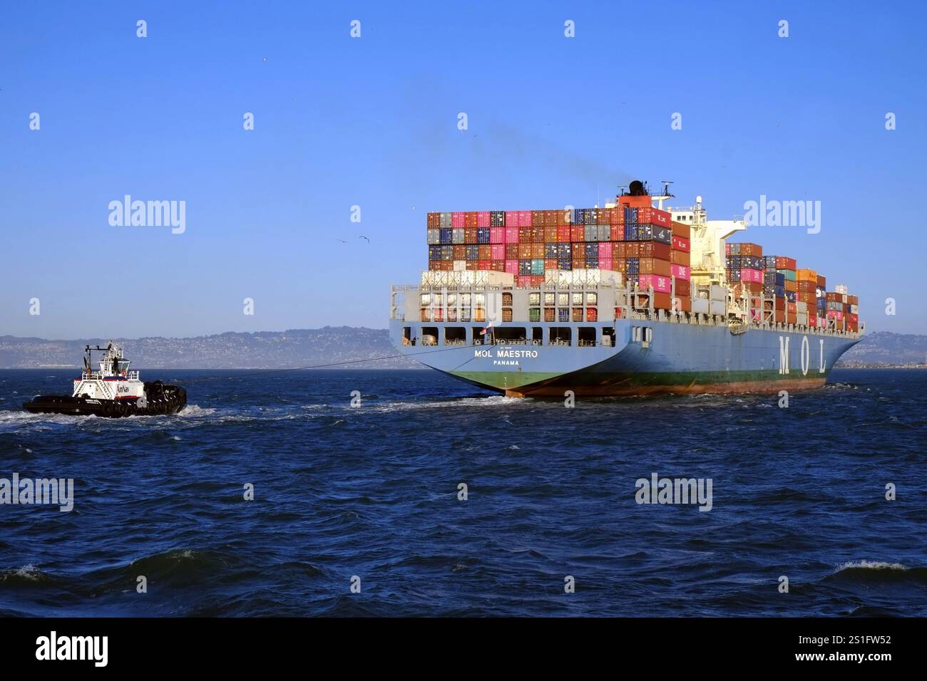 Accompanied by a harbour tug, a container ship enters San Francisco Bay ...