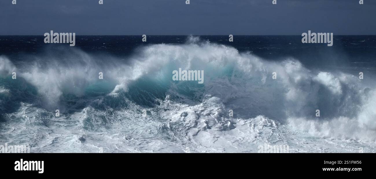 Turquoise-coloured wave crashes thunderously in the surf zone ...