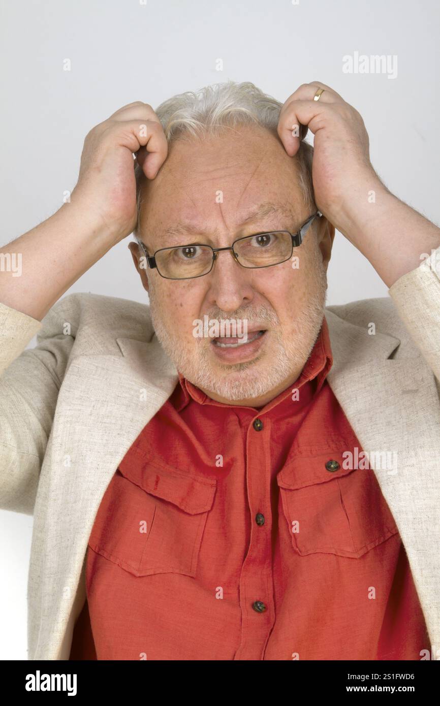 Senior in fear and panic on a light-coloured background Stock Photo - Alamy