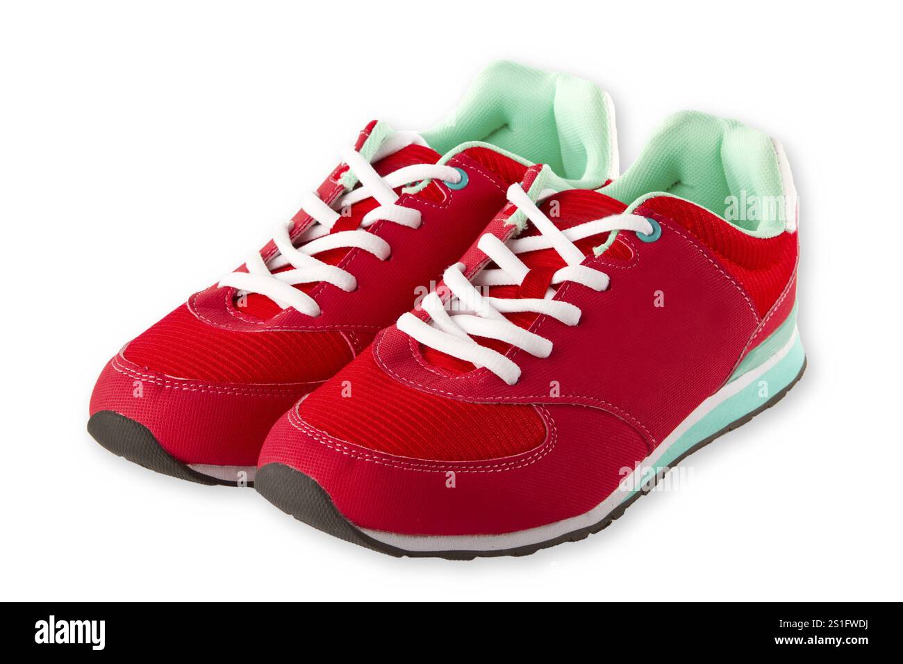 Red trainers cropped on a white background Stock Photo - Alamy