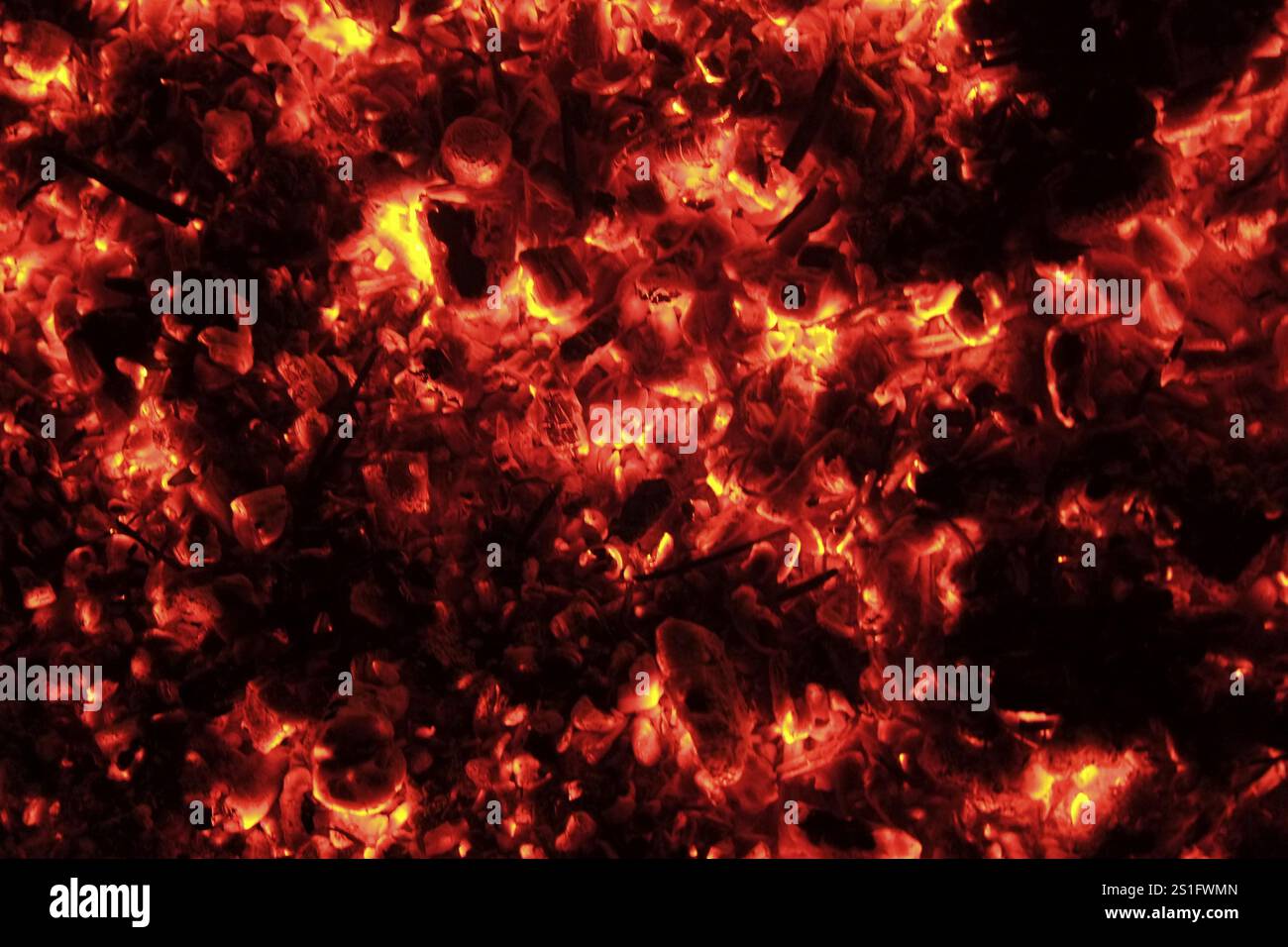 Red glowing remains of a wood fire. From above, landscape format. Red ...