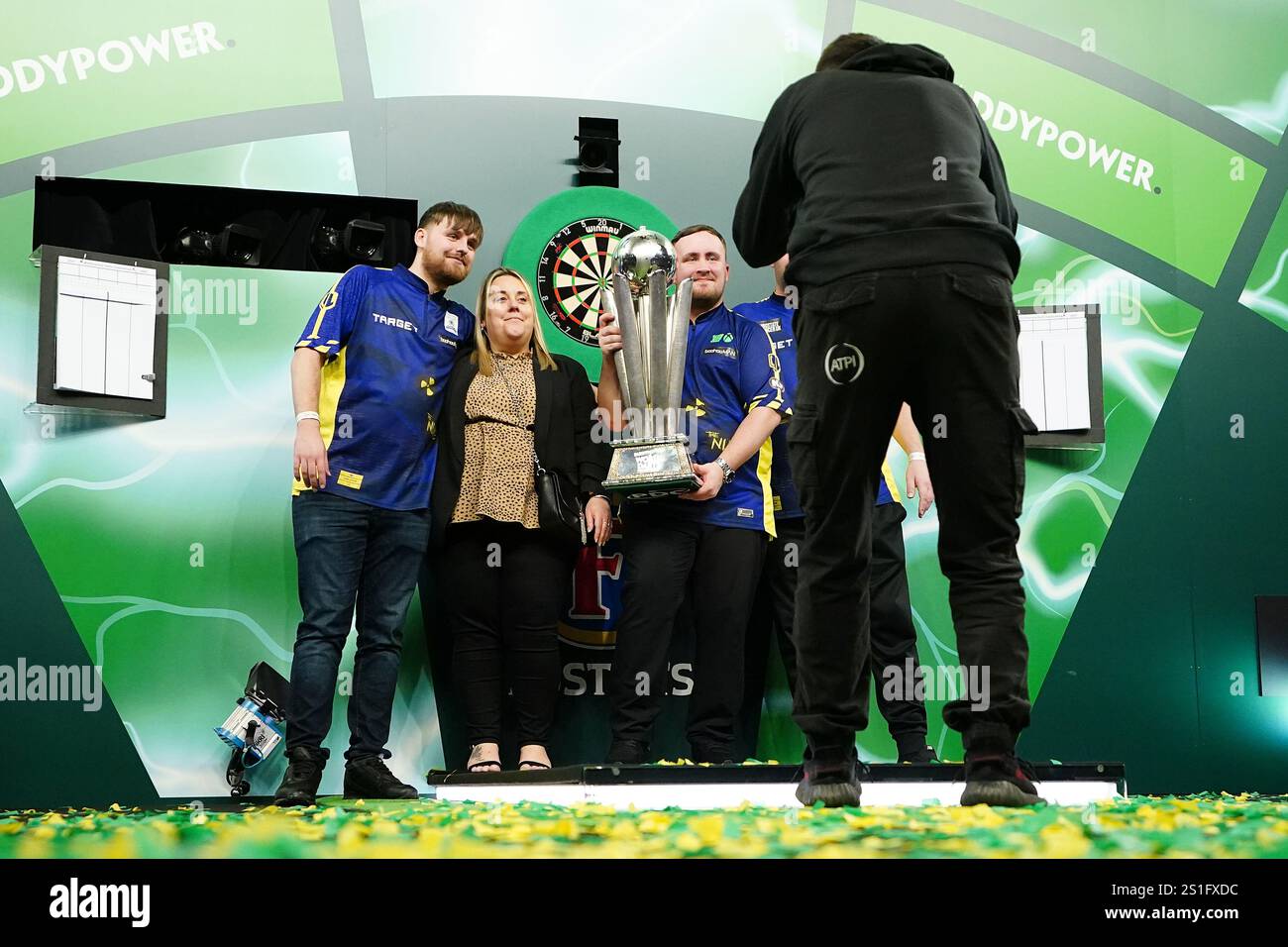 Luke Littler poses with his family and The Sid Waddell Trophy after ...