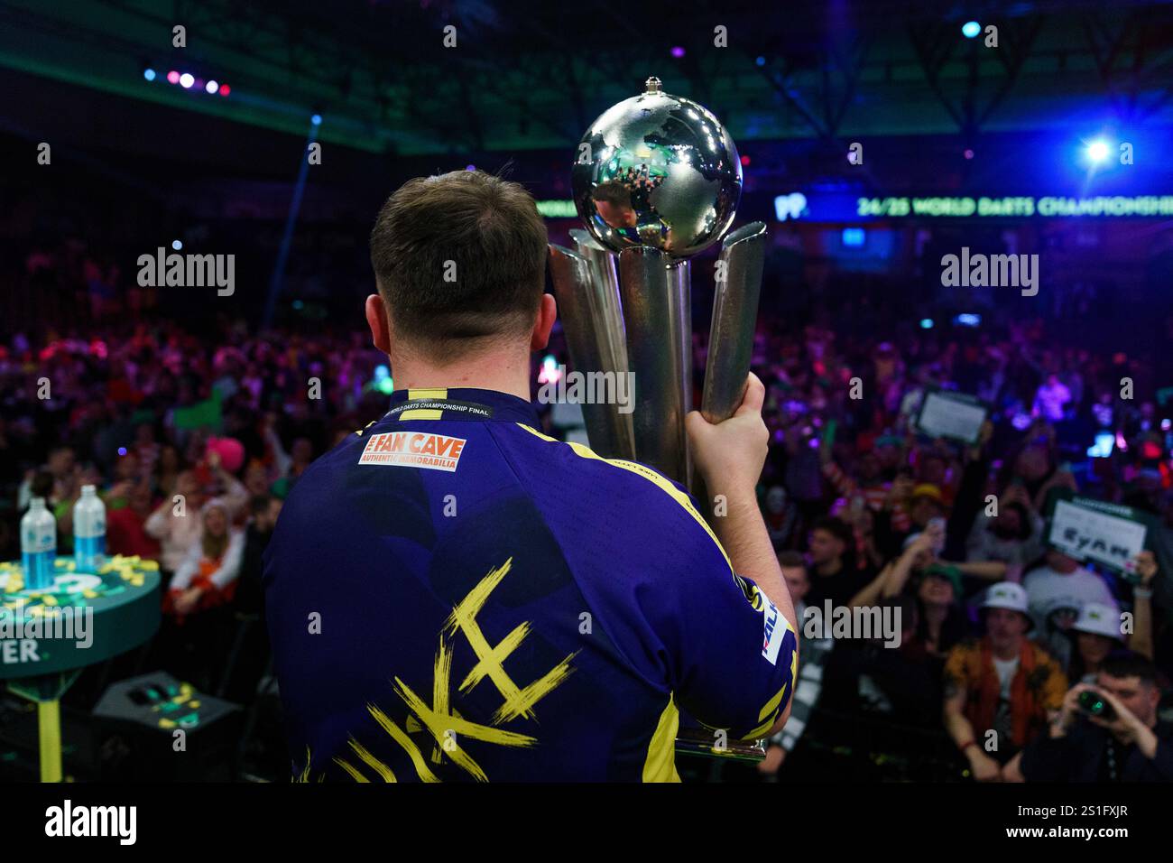 Luke Littler lifting the Paddy Power World Darts Championship trophy ...